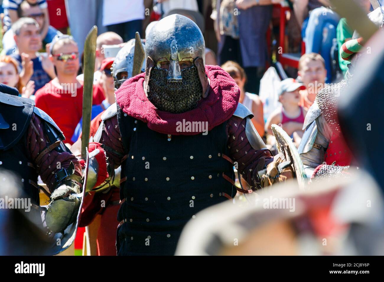 Knight Tournament. Medieval restorers fight with swords in armor at a ...