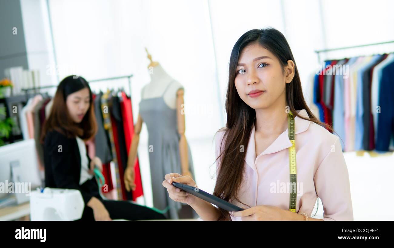 Portrait of Asia young designer working in the garment store Stock ...