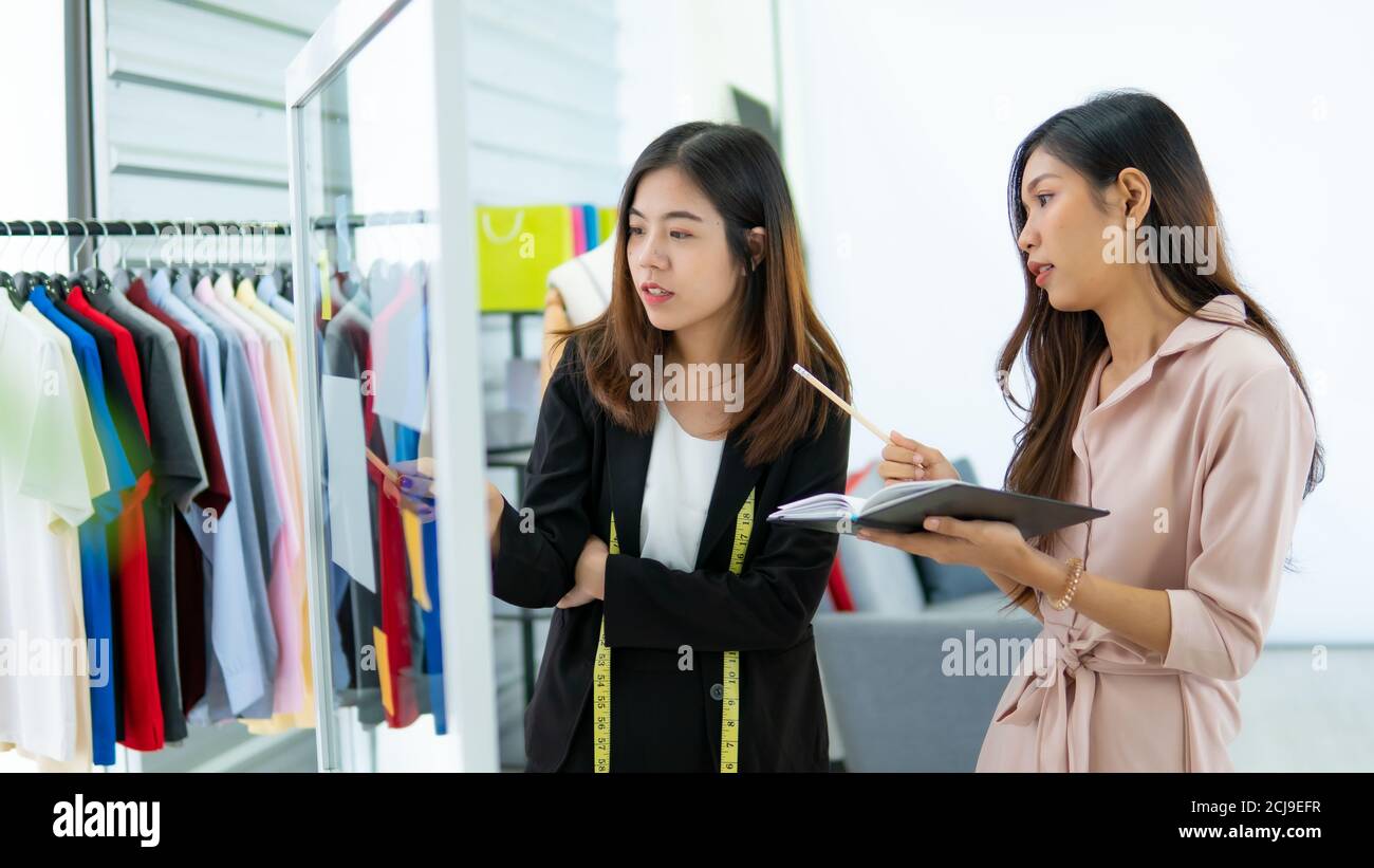Portrait of Asia young designer working in the garment store Stock ...