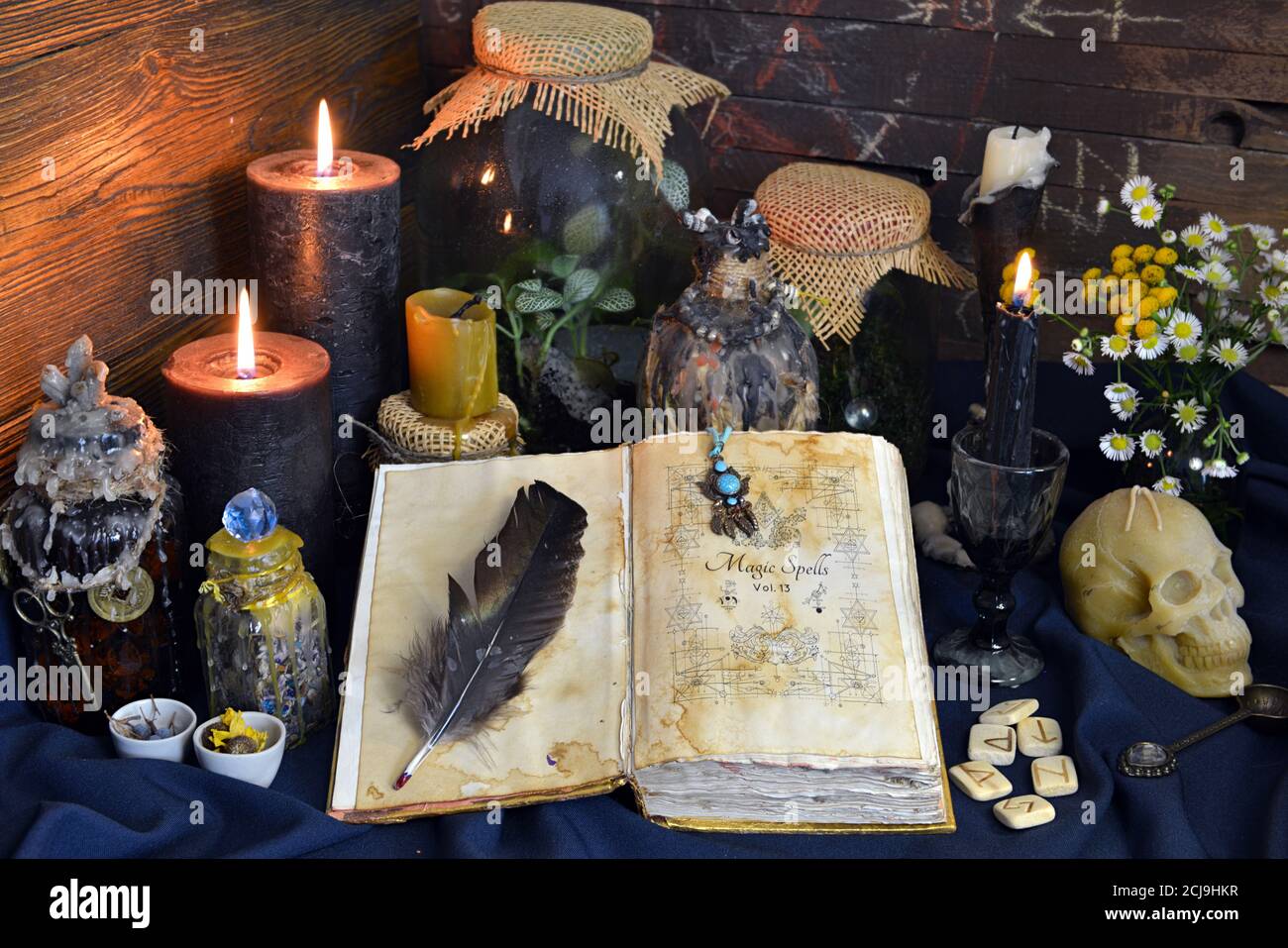 Still life with spell book, magic jars with plants and potion on witch ...