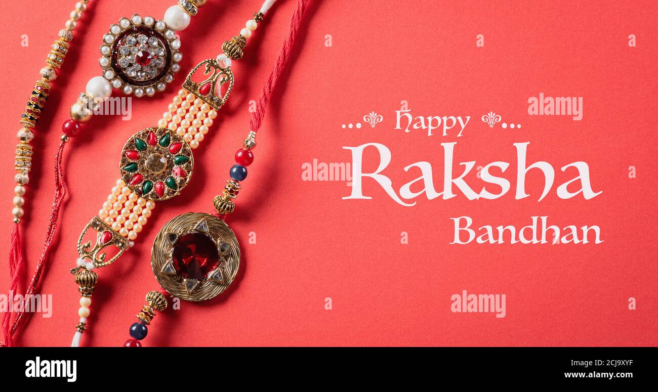Raksha Bandhan, Indian festival with beautiful Rakhi on red background ...
