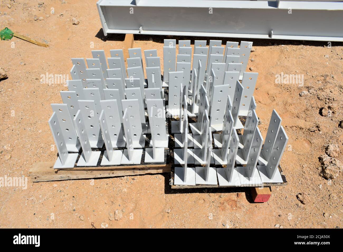 White painted steel structures on the desert ground Stock Photo - Alamy