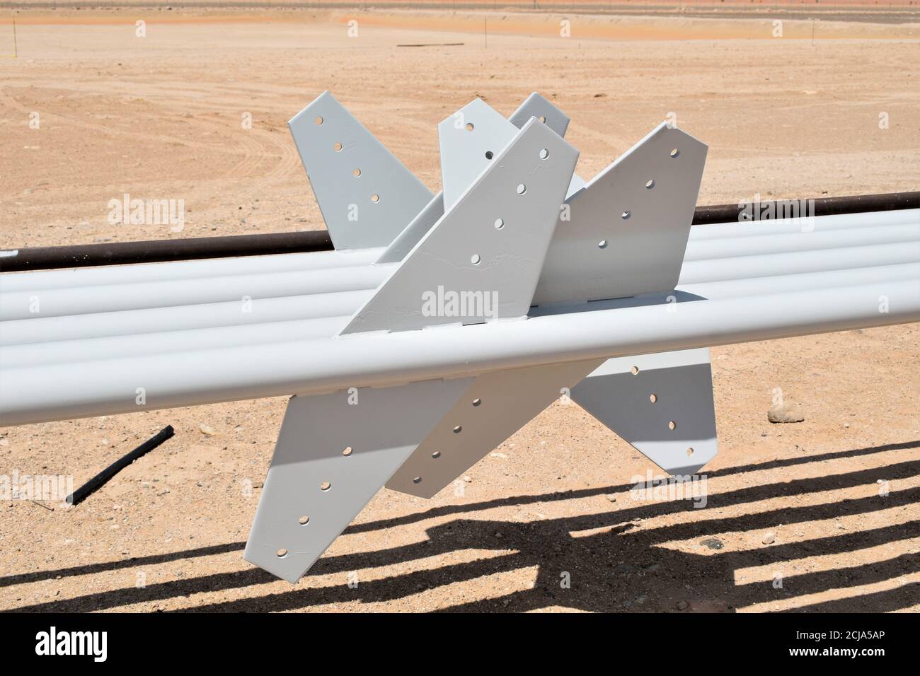 White painted steel structures on the desert ground Stock Photo - Alamy