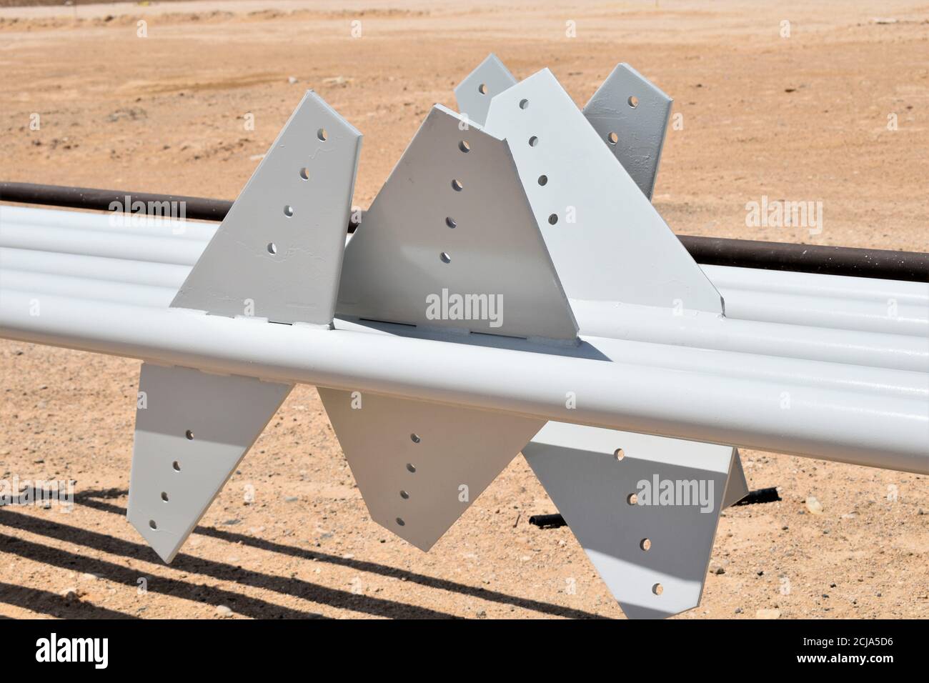 White painted steel structures on the desert ground Stock Photo - Alamy