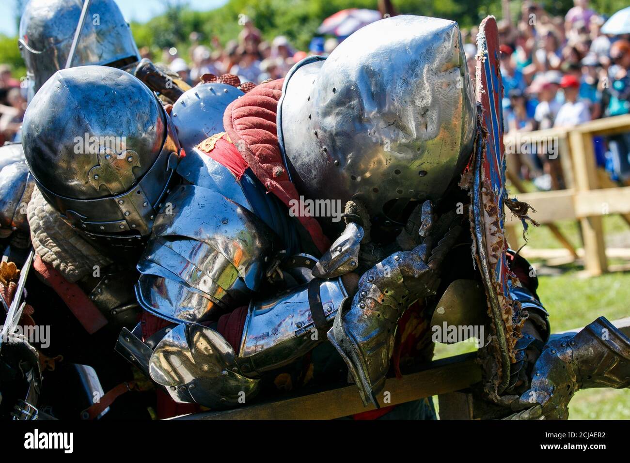 Knight Tournament. Medieval restorers fight with swords in armor at a ...