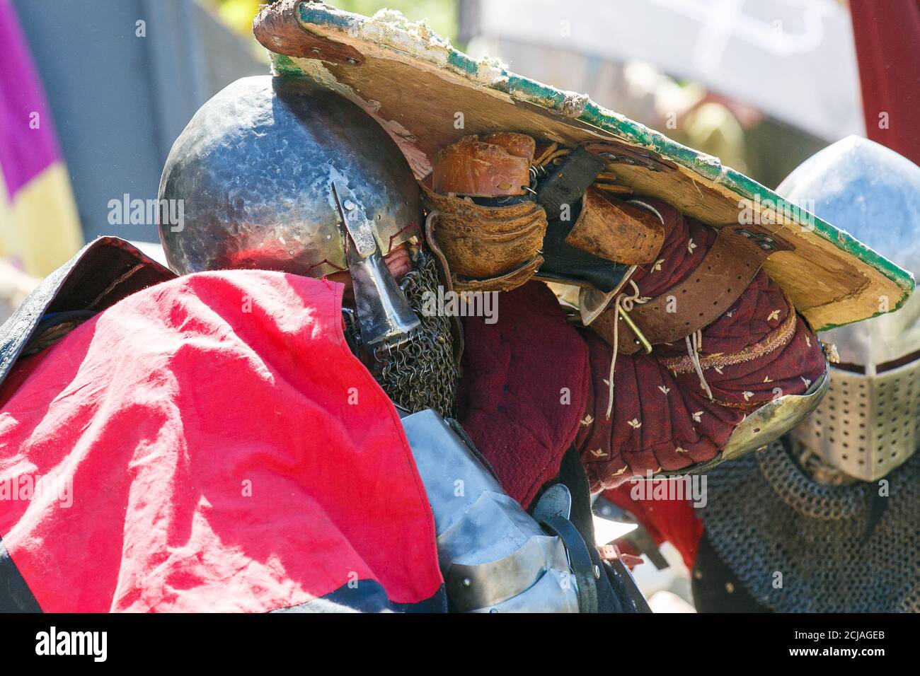 Knight Tournament. Medieval restorers fight with swords in armor at a ...