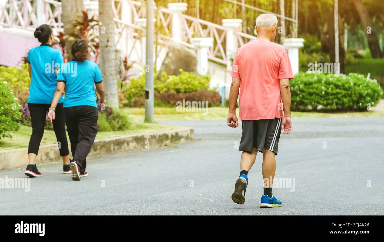 Back view portrait of a Asian elderly man in fitness wear walking and ...