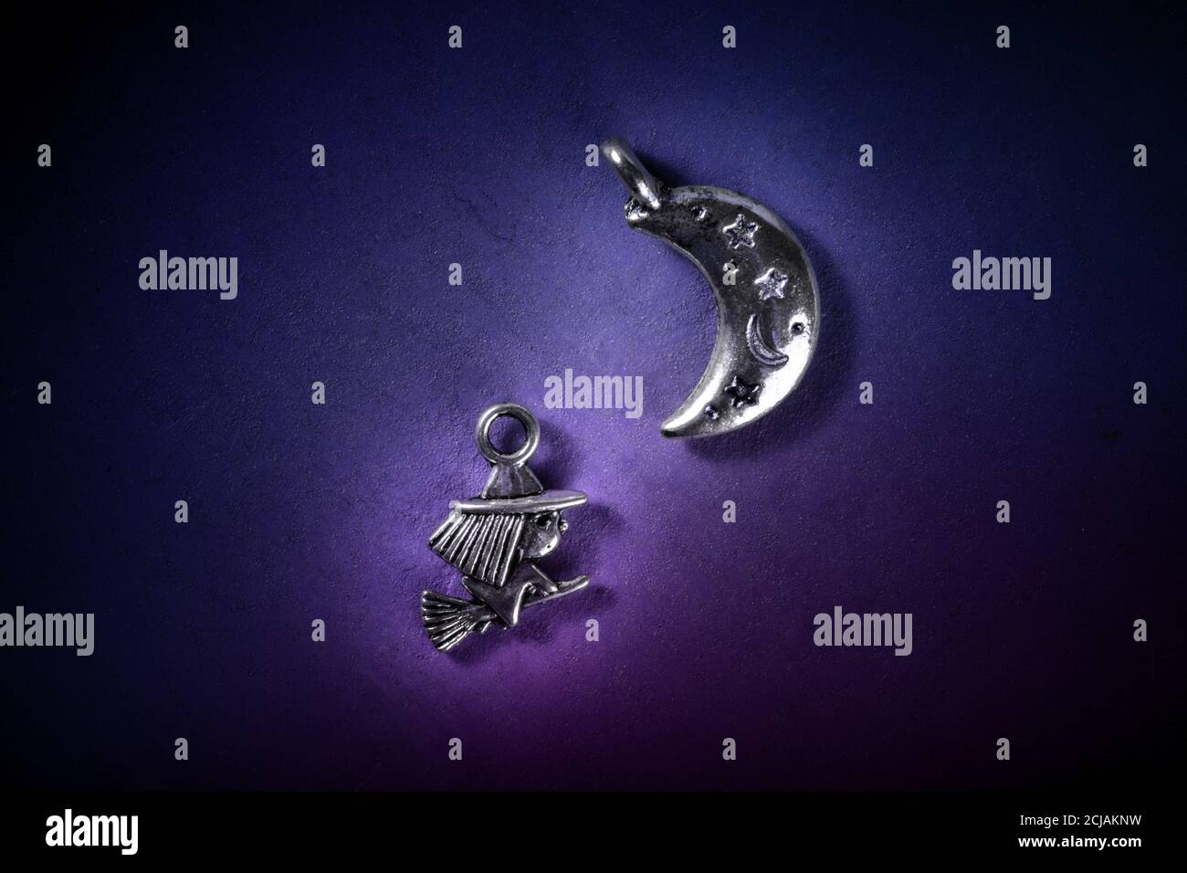 A witch flying to a sabbath under the Moon, Wiccan symbols on a dark ...