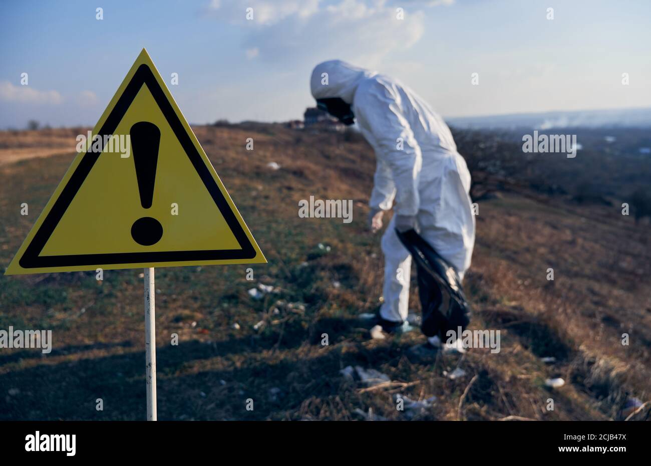 Warning sign about danger and hazards. On blurred background ...