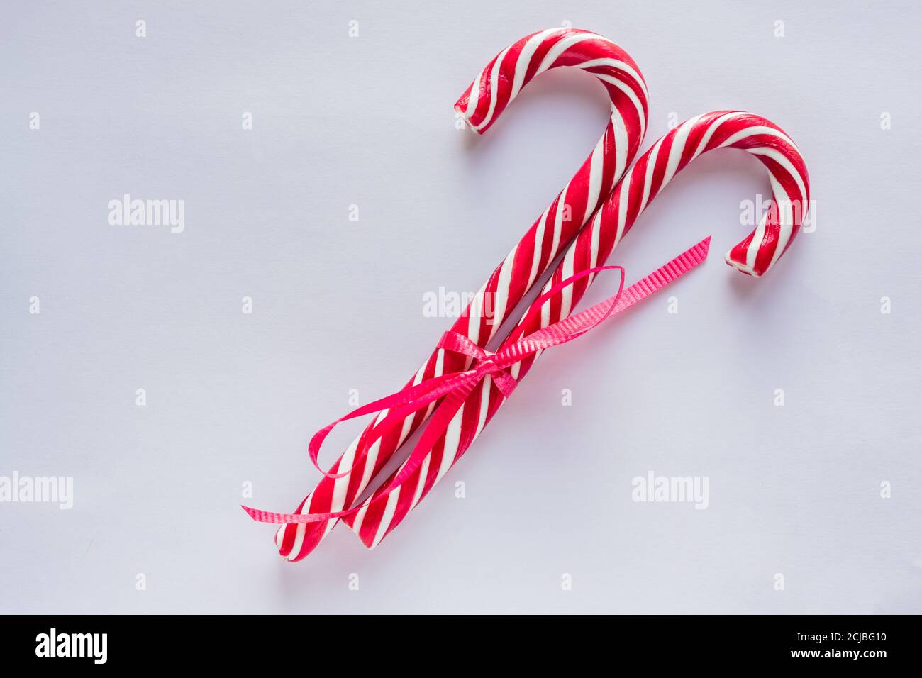 two candy canes on white background. Traditional Christmas candies ...