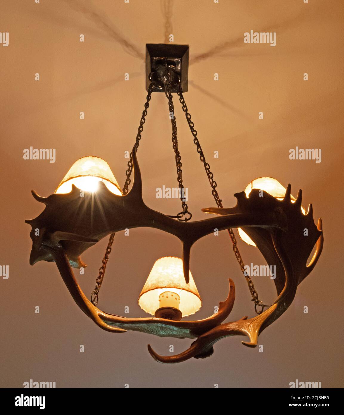 Very old antler chandelier, hanging on the ceiling Stock Photo - Alamy