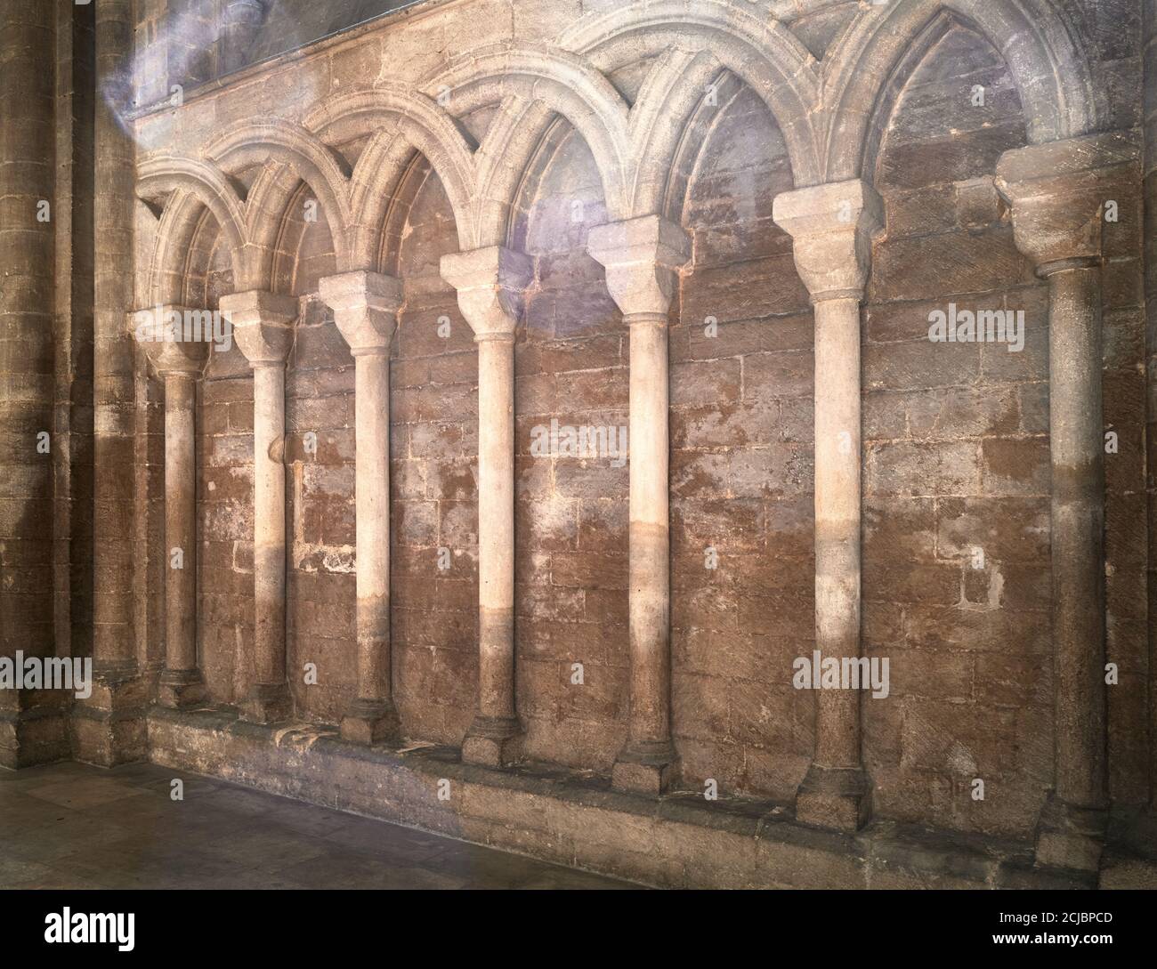 Interleaved, decorative stone round arch pillars on the wall of the ...