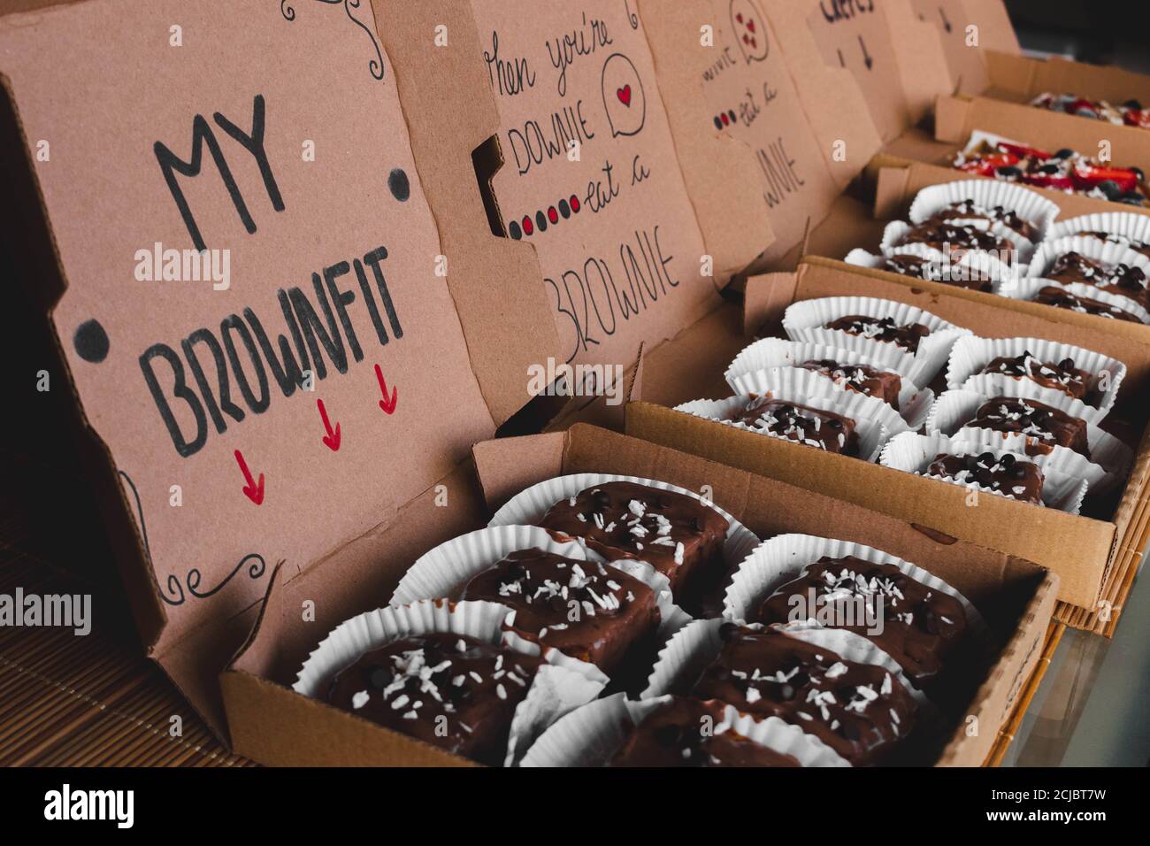 Closeup shot of takeaway food boxes with brownies and cute inscriptions ...