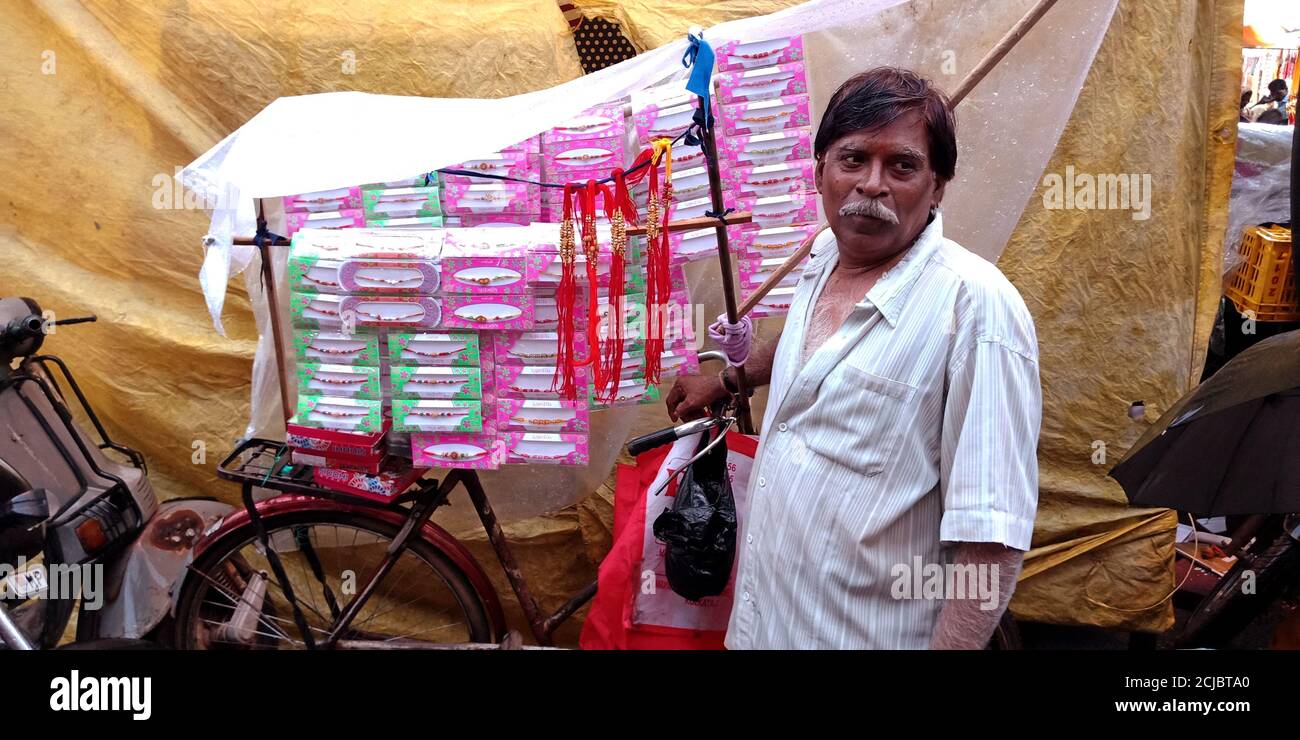 DISTRICT KATNI, INDIA - AUGUST 14, 2019: Asian shopkeeper presenting ...