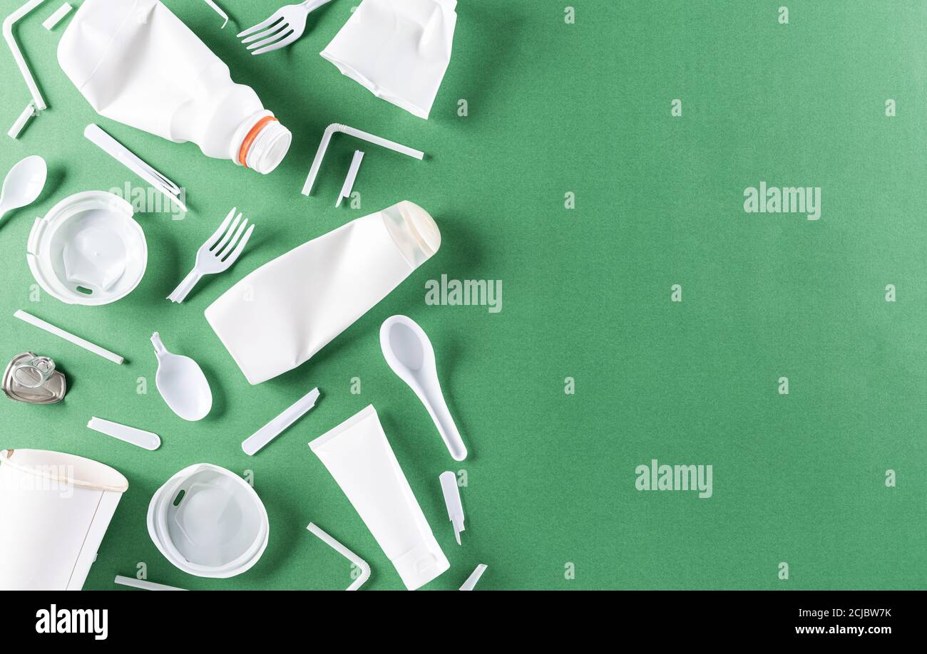 Top view of Different garbage materials on green pastel background ...