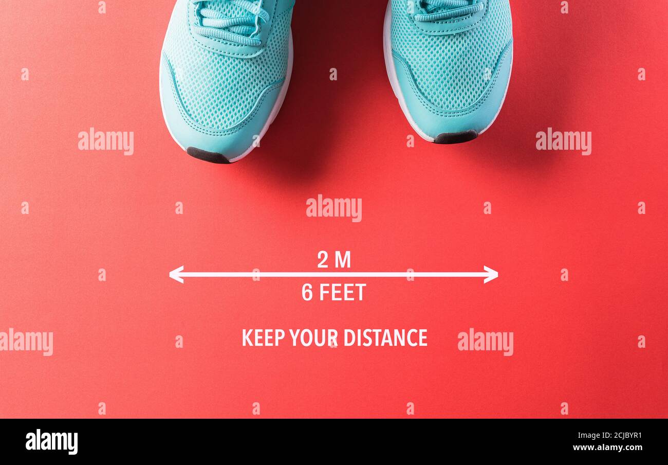 Social Distancing concept. Shoes with text Social Distance on red ...