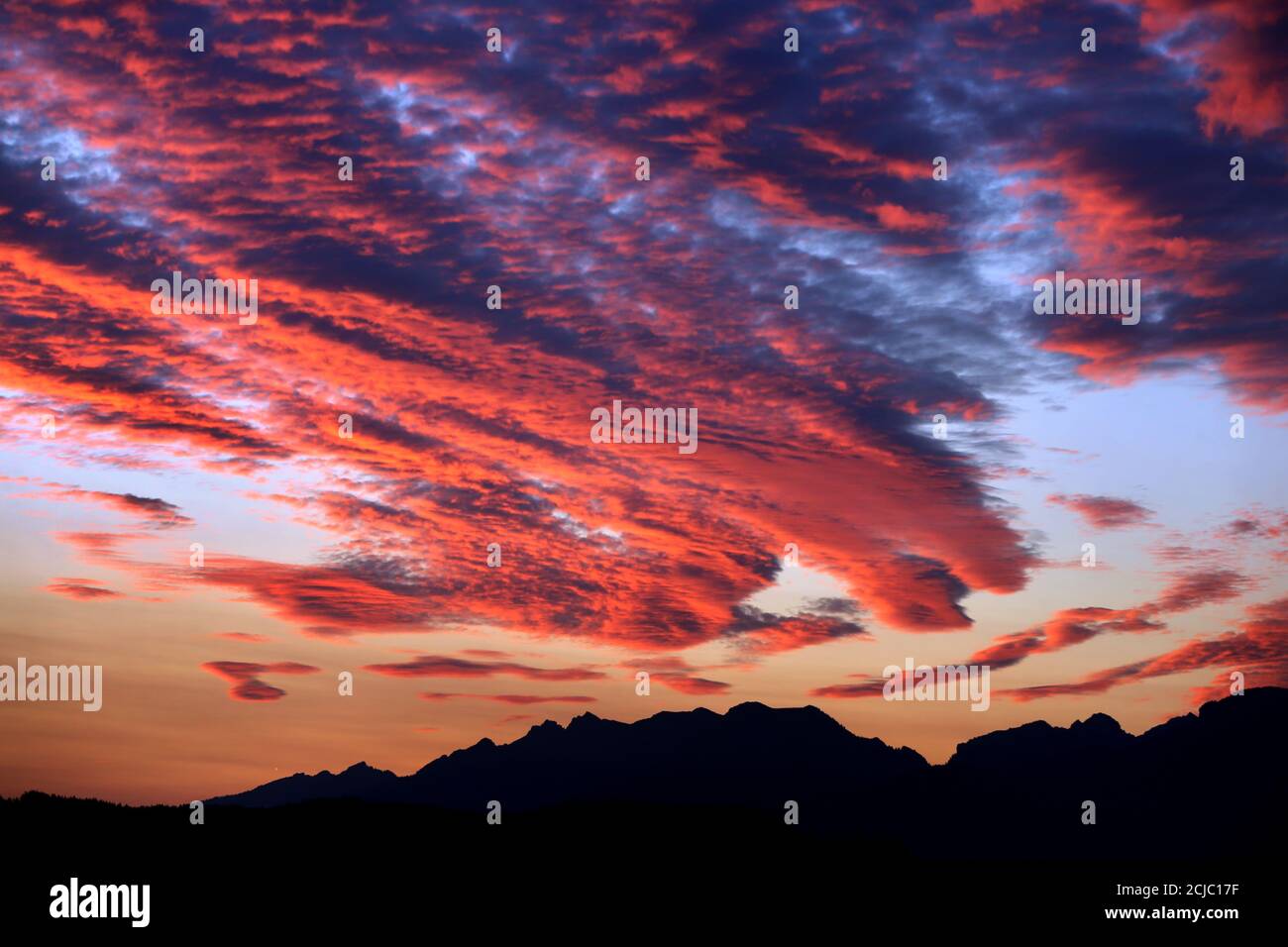 Seeg, Germany. 15th Sep, 2020. The rising sun colours the clouds above ...