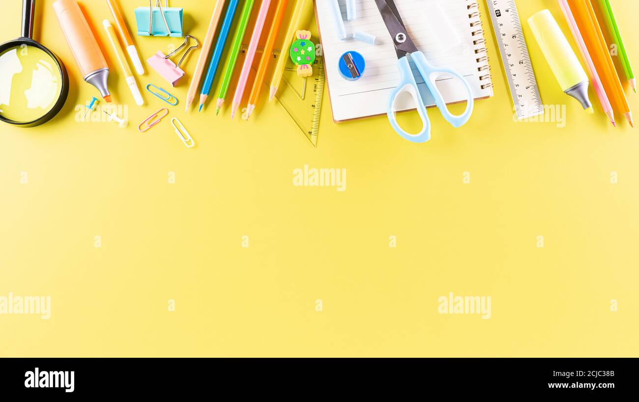 School supplies on yellow paper background. Back to school concept with ...