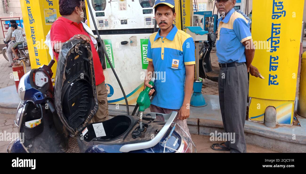 DISTRICT KATNI, INDIA - SEPTEMBER 04, 2019: Asian petrol pump attender ...
