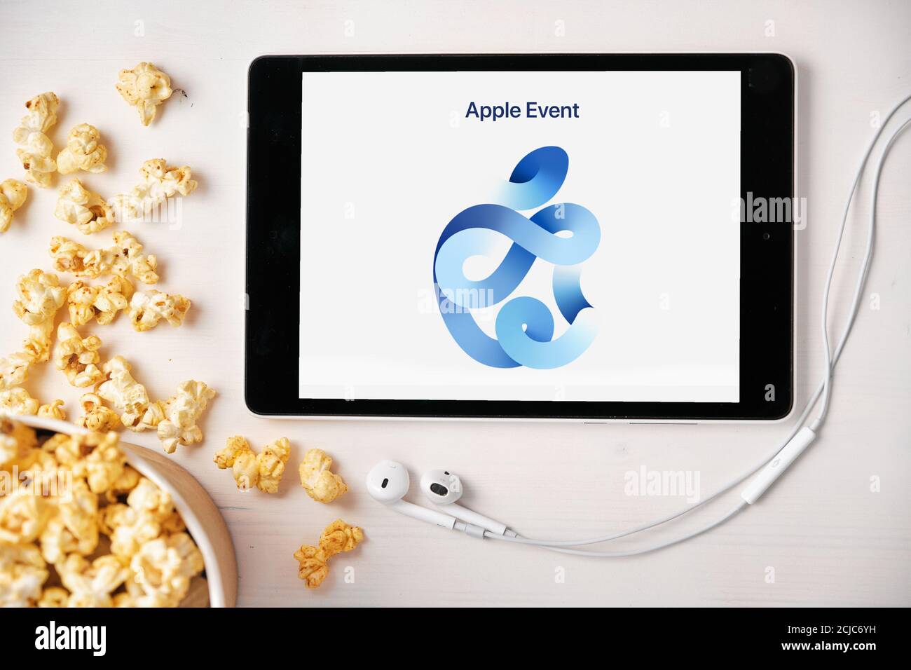 Man is watching Apple event 2020 using IPhone. Apple logo on the device ...