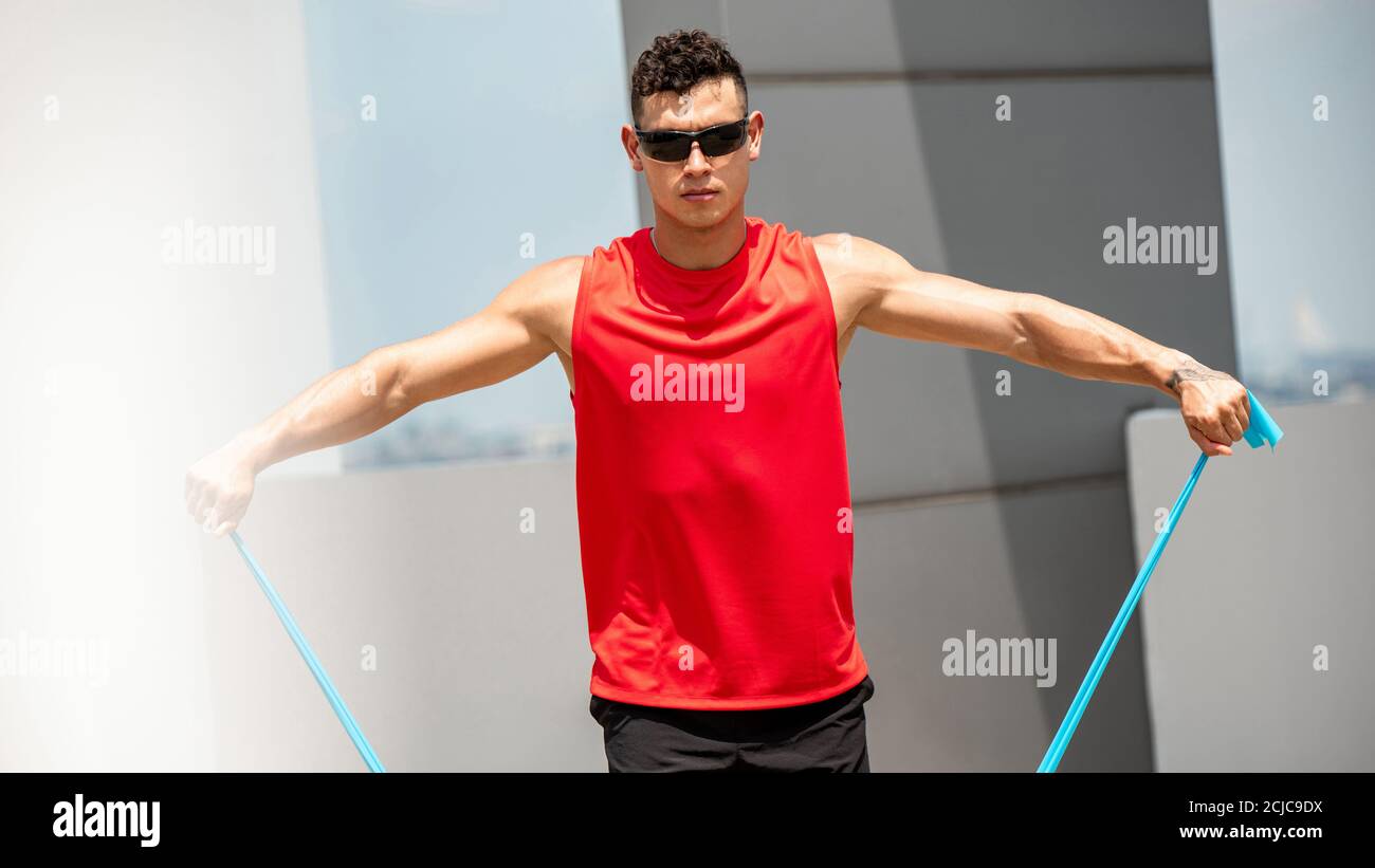 Handsome sportsman doing shoulder lateral raise exercise with ...