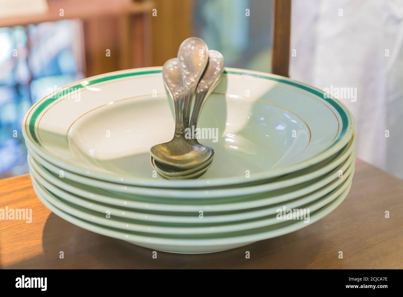 stack of plates and spoon ready for serving dinner. Rustic style Stock ...