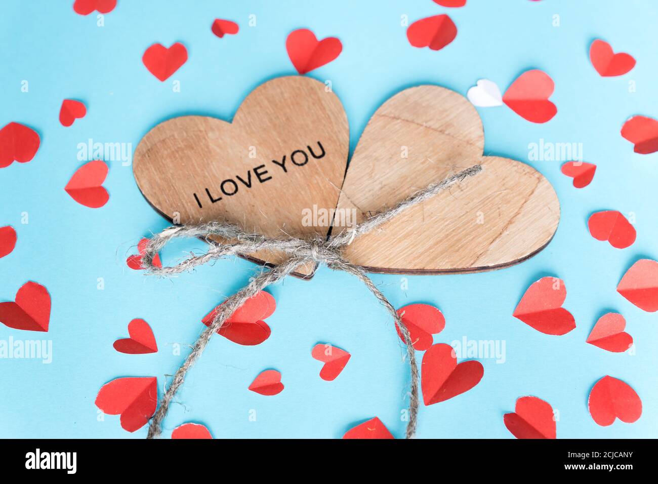 valentines day and holidays concept - two wooden hearts, cut out paper ...