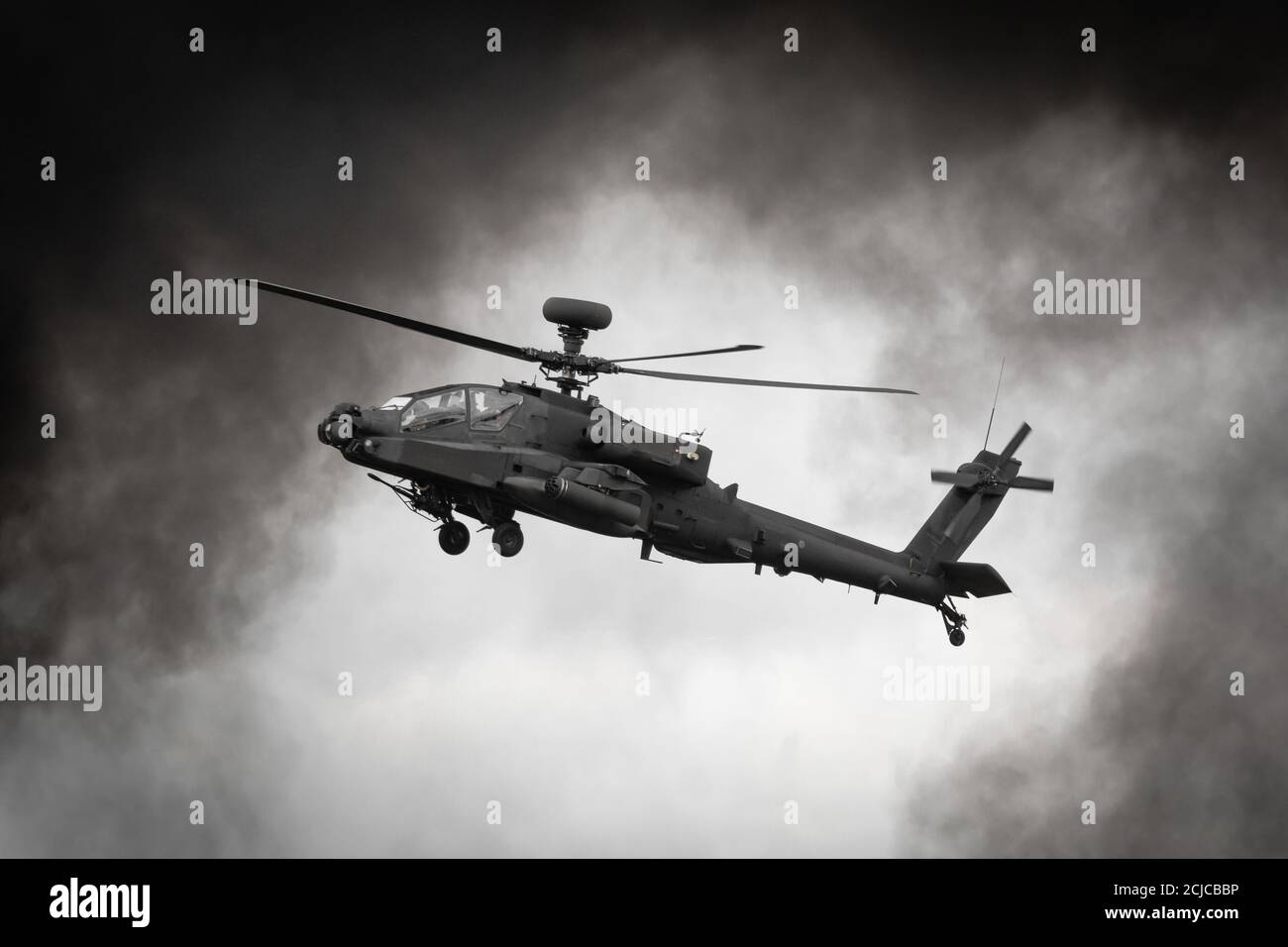 The army apache helicopter flies away whilst being silhoutted by the ...