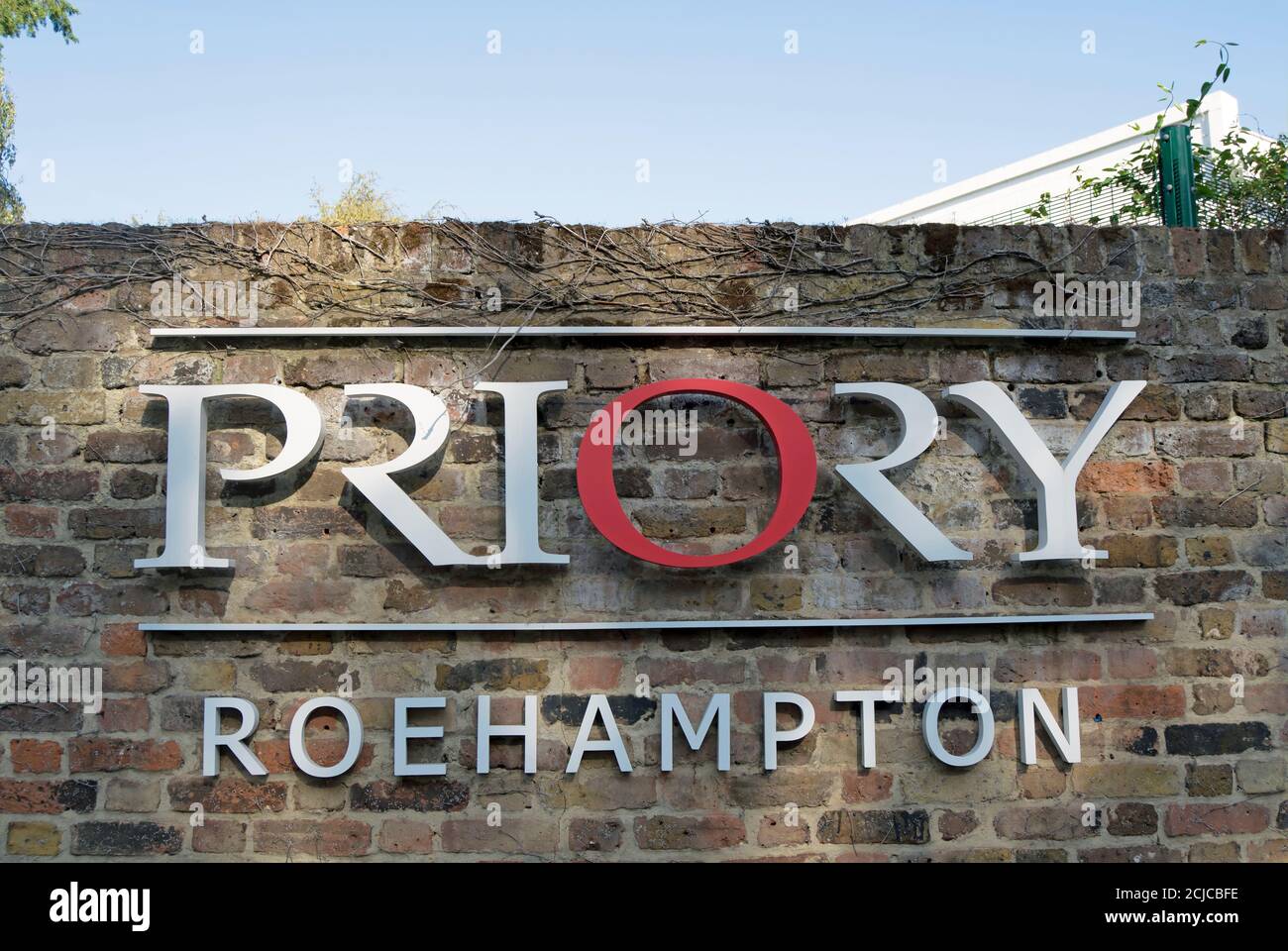 wall sign at the entrance to the priory hospital, roehampton, england ...