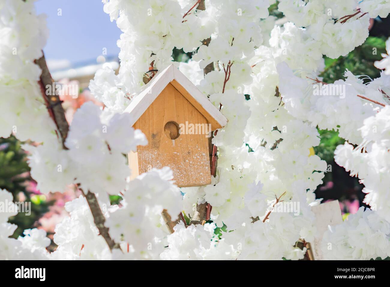 Decorative bird house in blooming cherry tree. spring background Stock ...