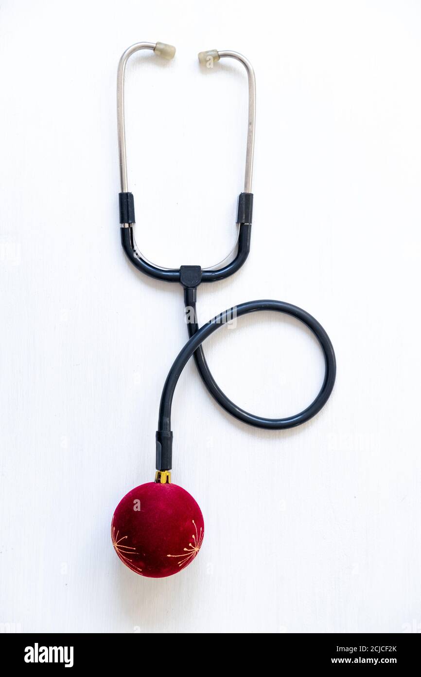 Creative Medical Christmas card stethoscope and red ball on white ...