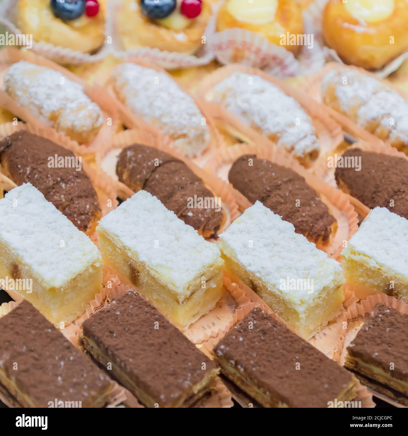 Pastry shop display window with variety of mini desserts and cakes ...