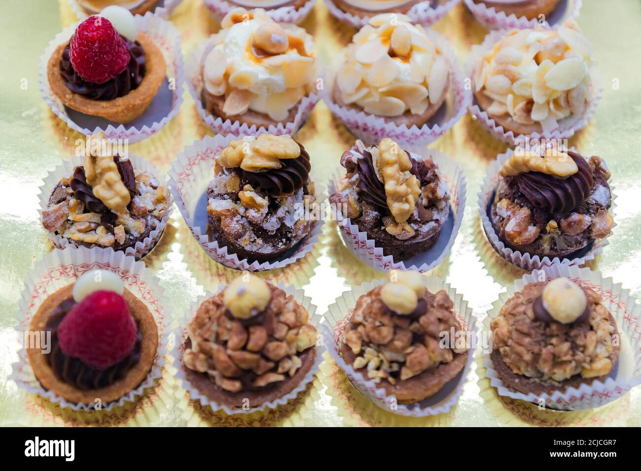 Pastry shop display window with variety of mini desserts and cakes ...