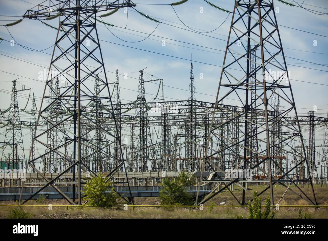 High voltage transformer and distributive substation. Electric pylons ...