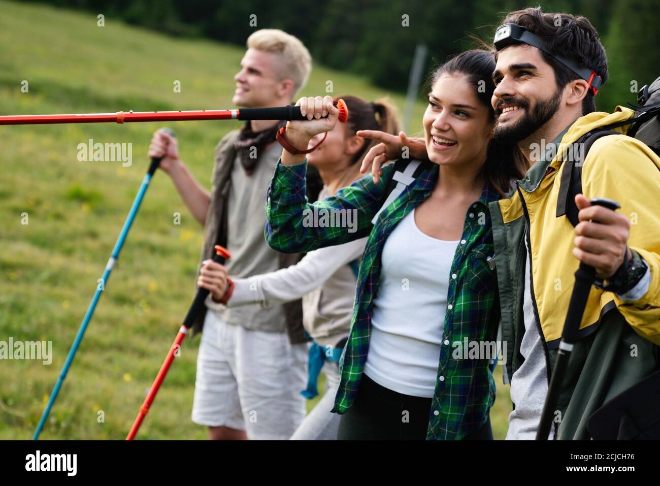Group of friends hiking together outdoors exploring the wilderness and ...