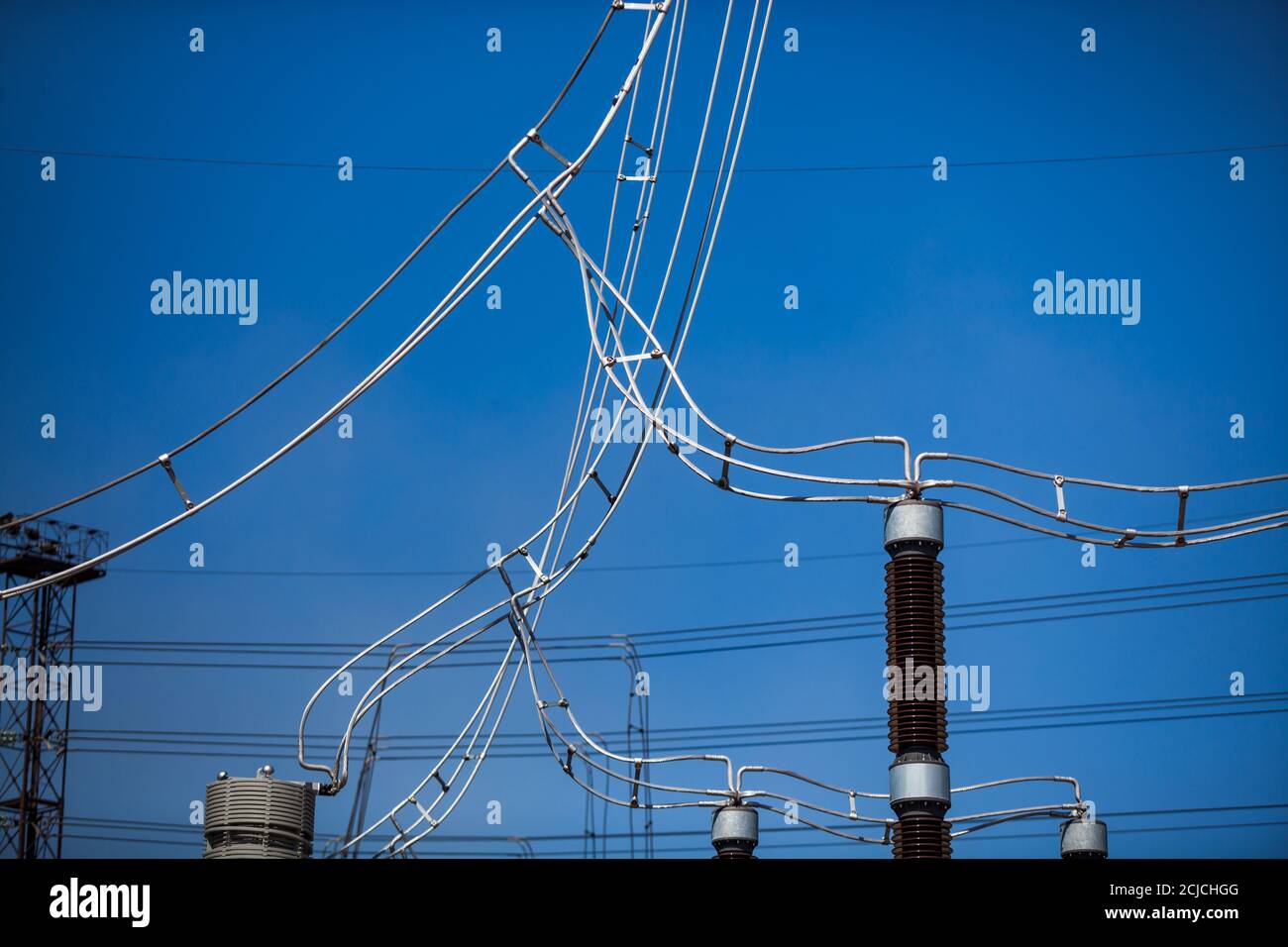 Close-up of insulators (isolators) and power grid and cables or wires ...