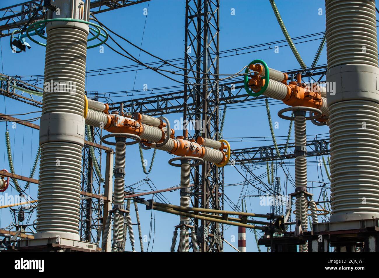 Power generating plant. Transformer substation on blue factory building ...