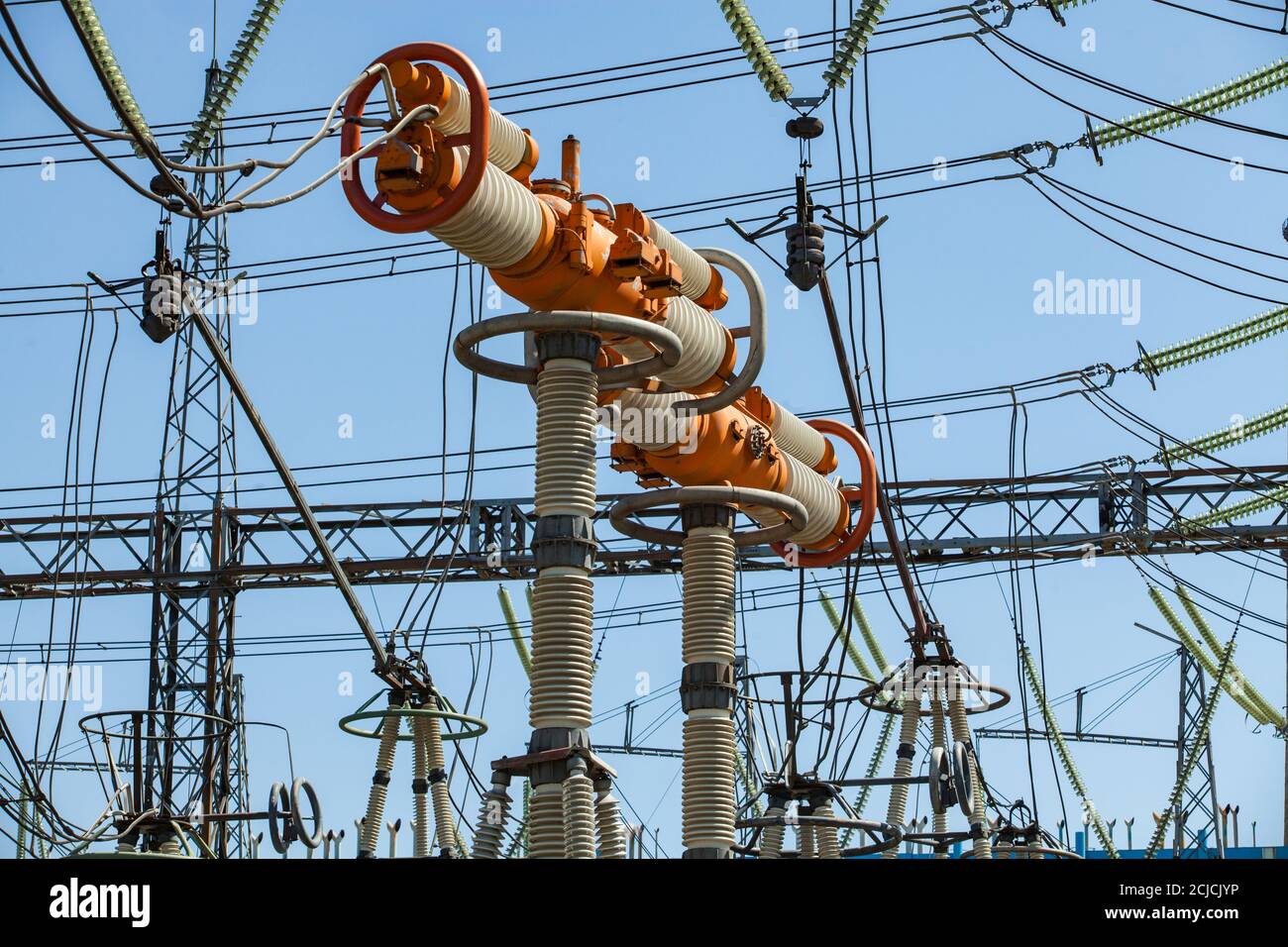 Electric switcher and glass insulators on blue sky background. High ...