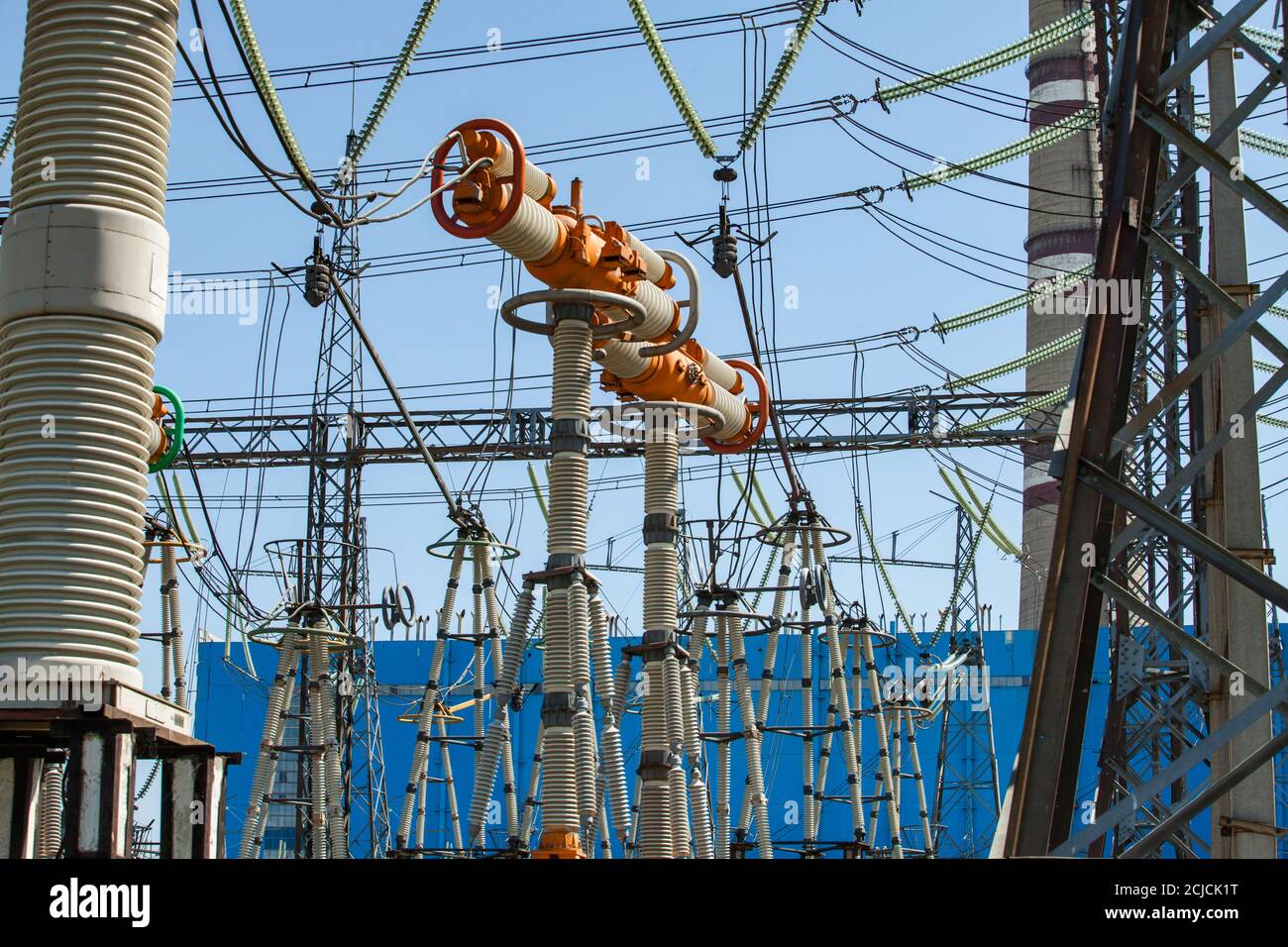 Power generating plant. Transformer substation on blue factory building ...