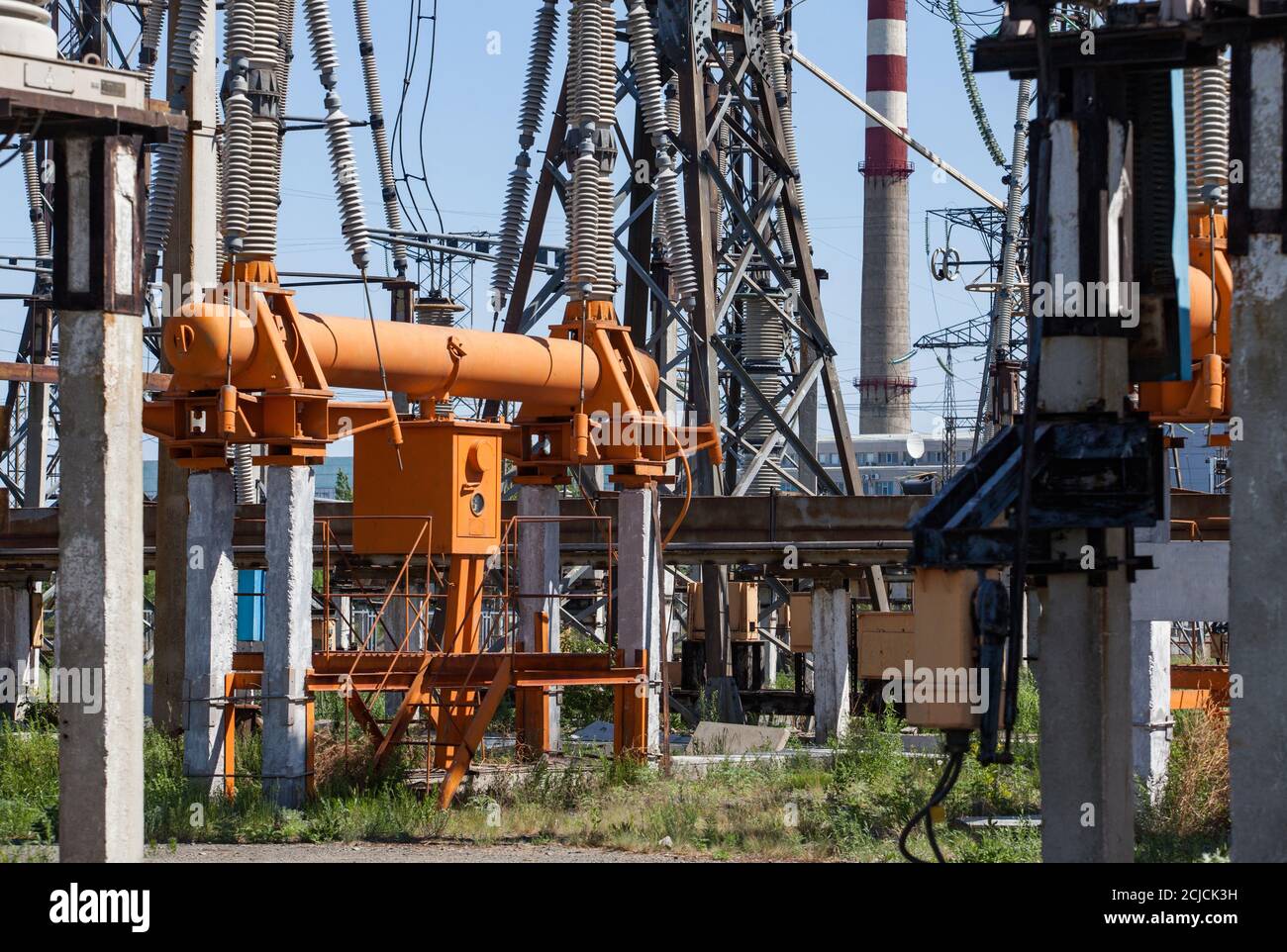 Transformer substation on blue sky background. Orange high-voltage ...