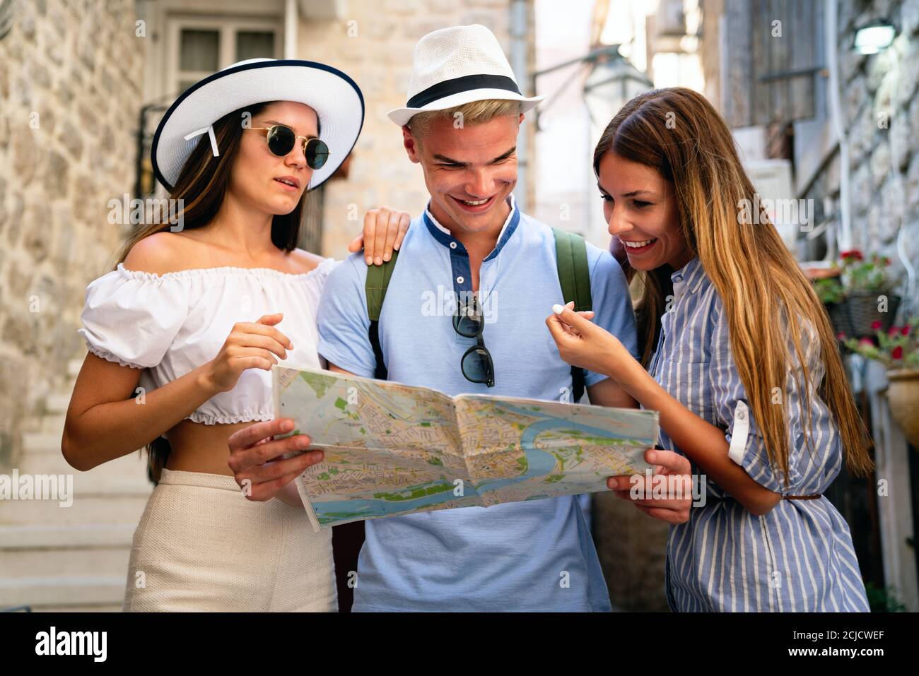 Happy group of friends tourists sightseeing in city on vacation Stock ...