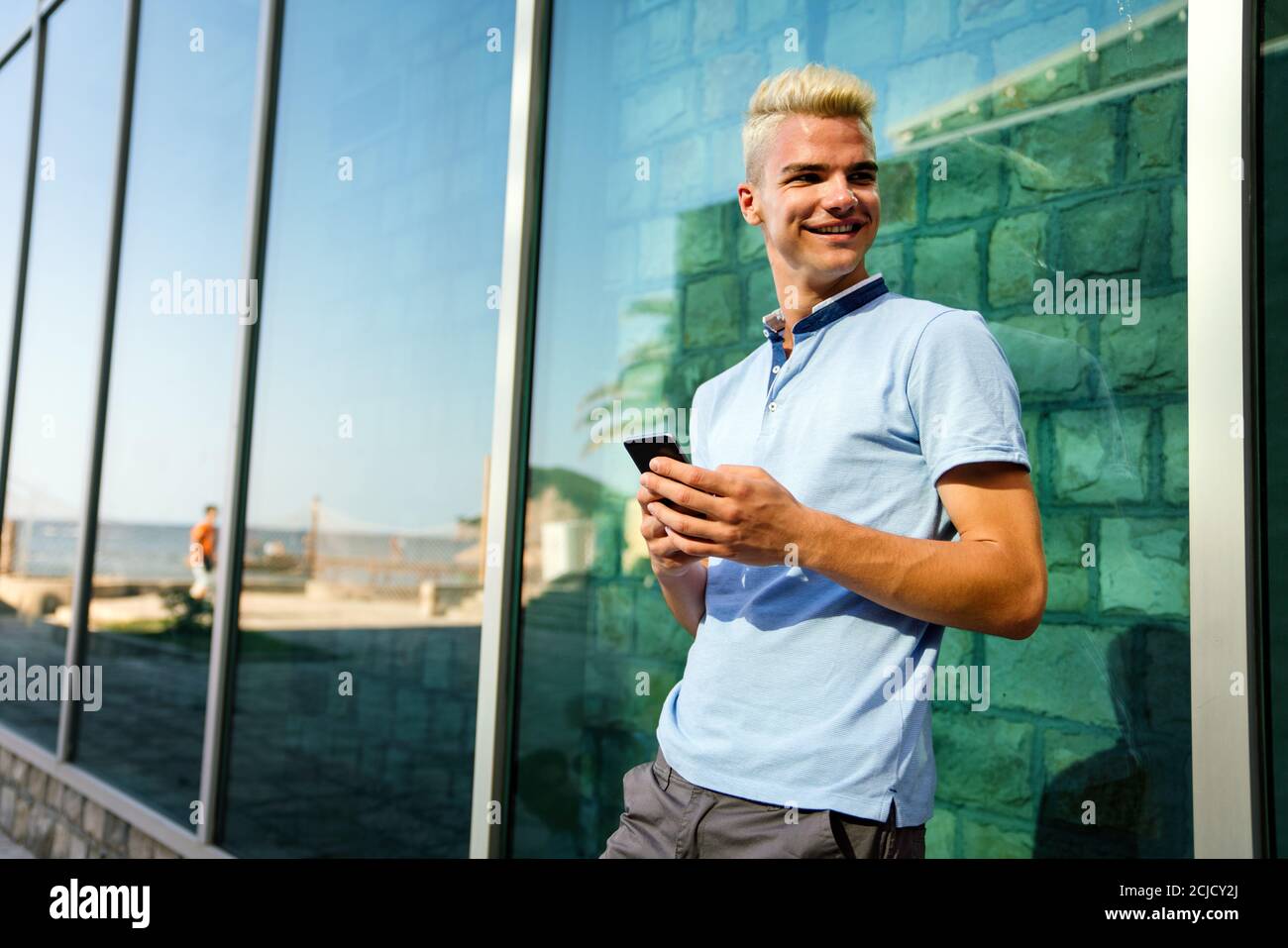 Portrait young man mobile phone outdoors hi-res stock photography and ...