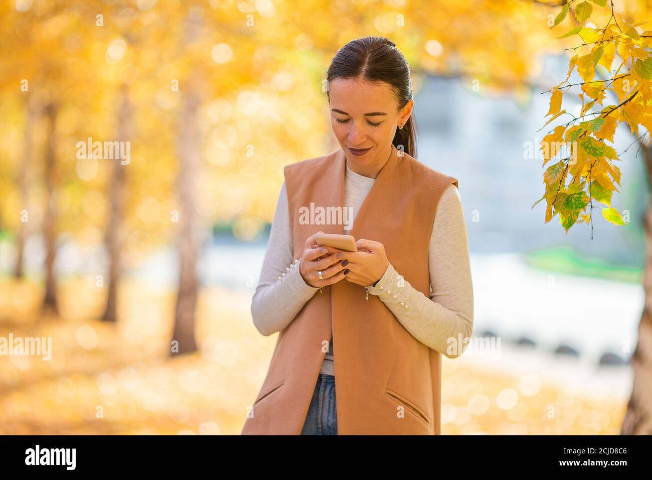 Fall concept - beautiful woman in autumn park under fall foliage Stock ...