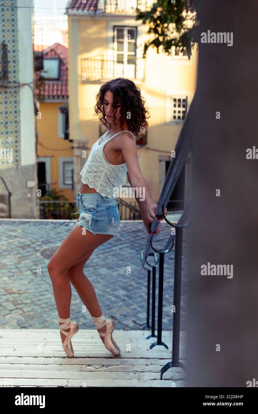 Young ballet dancer posing in the urban scenery of the city in Lisbon ...
