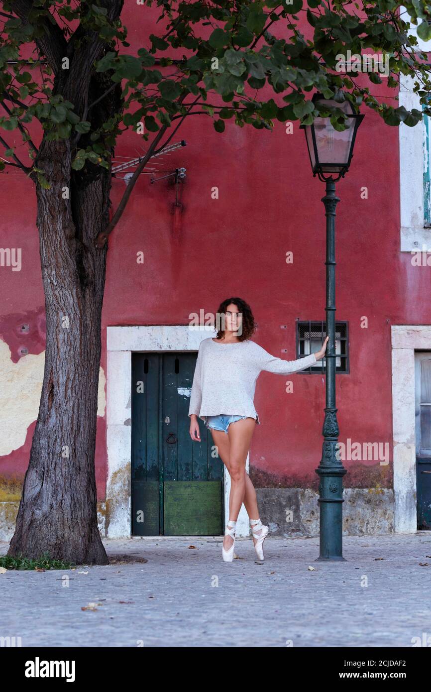 Young ballet dancer posing in the urban scenery of the city in Lisbon ...