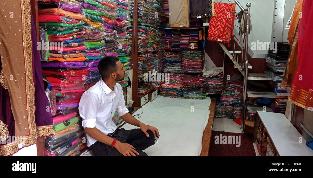 DISTRICT KATNI, INDIA - SEPTEMBER 22, 2019: An asian shopkeeper sitting ...