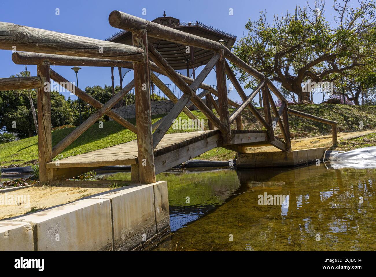 Wooden bridge over a river in a park in Malaga, Paisaje Stock Photo - Alamy