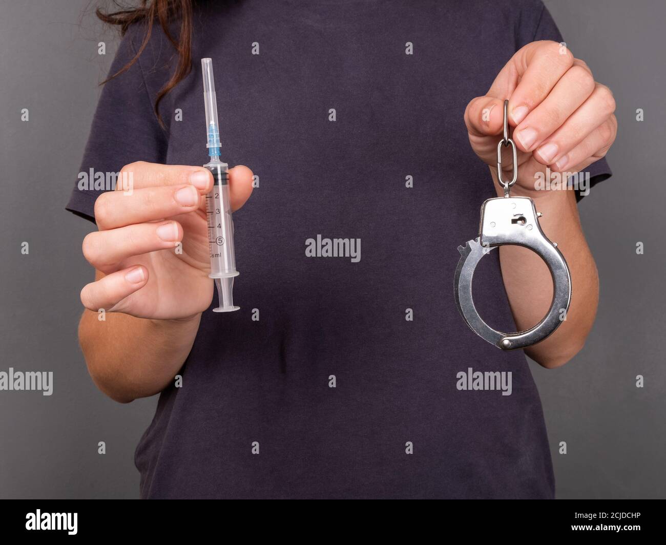 punishment for drug use, handcuffs and syringe close up Stock Photo - Alamy