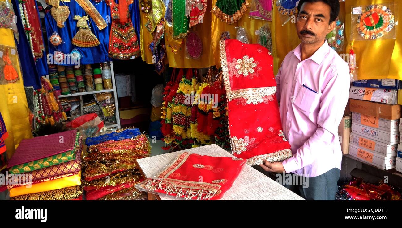 DISTRICT KATNI, INDIA - SEPTEMBER 24, 2019: Asian shopkeeper presented ...