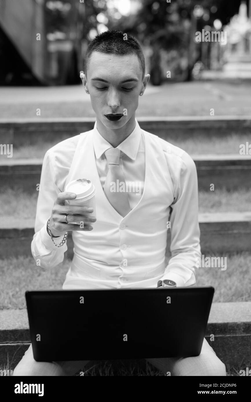 Young handsome androgynous businessman exploring around the city Stock ...